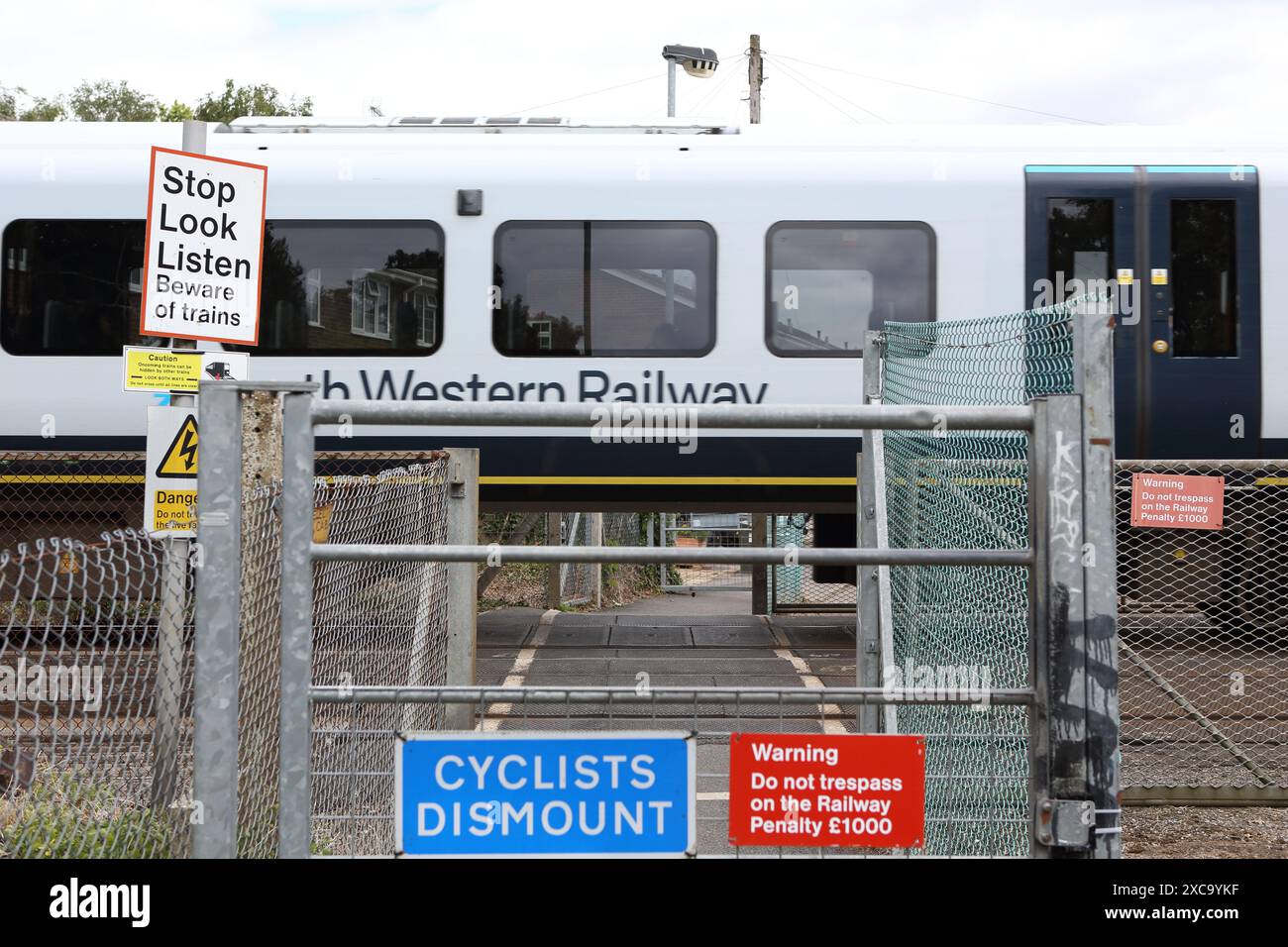 Railway foot crossing Frimley Green Hampshire UK with warning signs ...