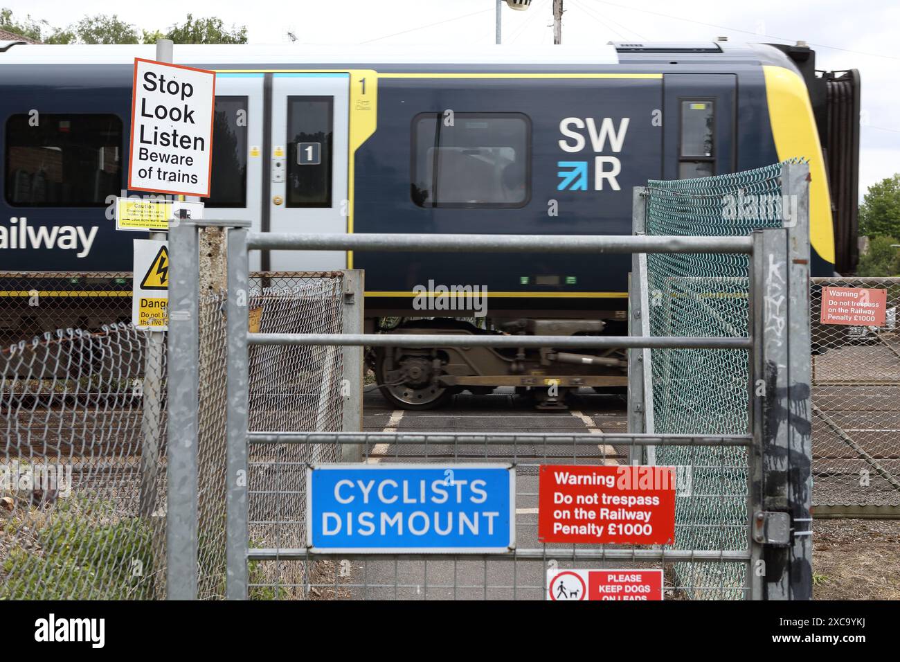 Railway foot crossing Frimley Green Hampshire UK with warning signs ...