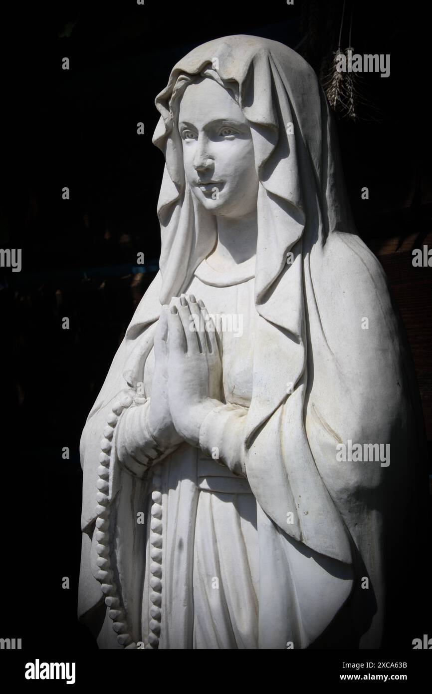 The statue of Virgin Mary holding hands, in gesture of praying in ...
