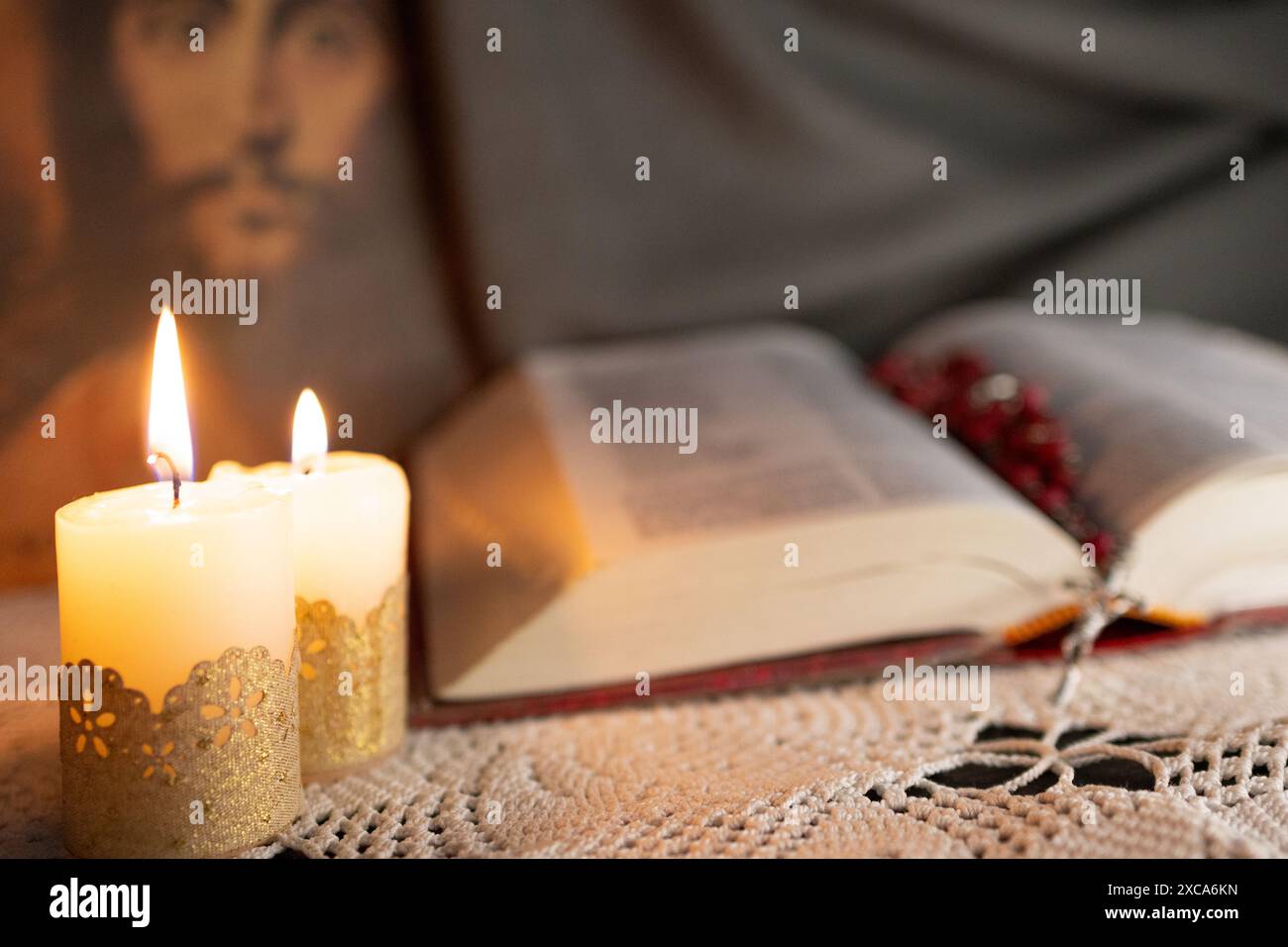Bible and rosary illuminated by candlelight.Culture of faith Stock ...