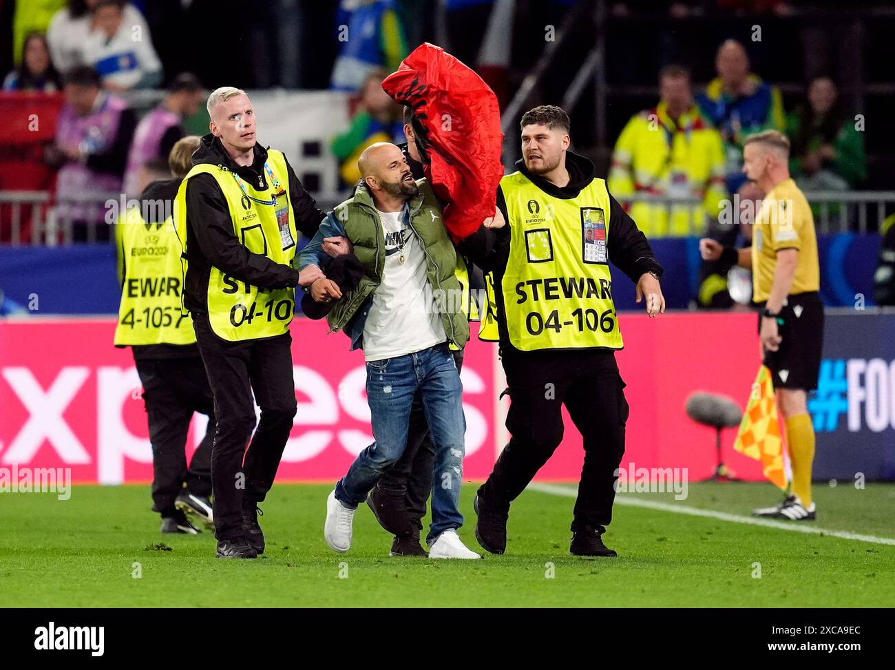 A pitch invader is escorted off by stewards during the UEFA Euro 2024 ...