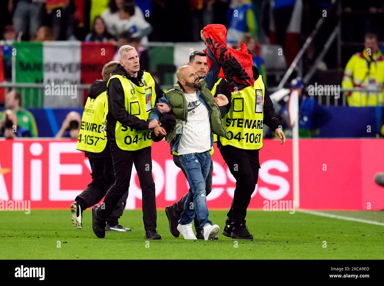 A pitch invader is escorted off by stewards during the UEFA Euro 2024 ...