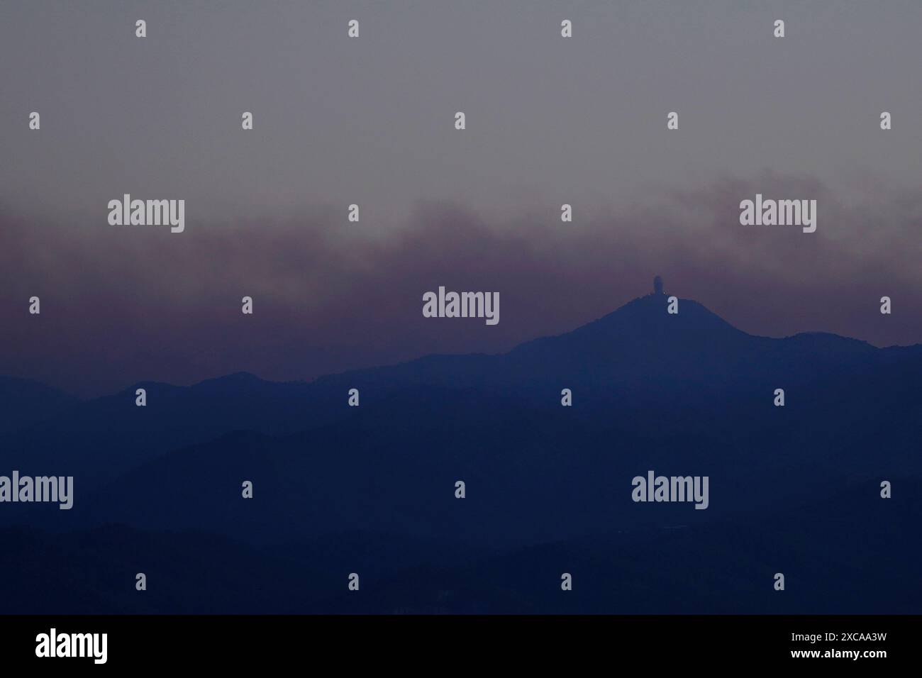 Smoke from a wildfire drifts over Troodos mountain between villages ...