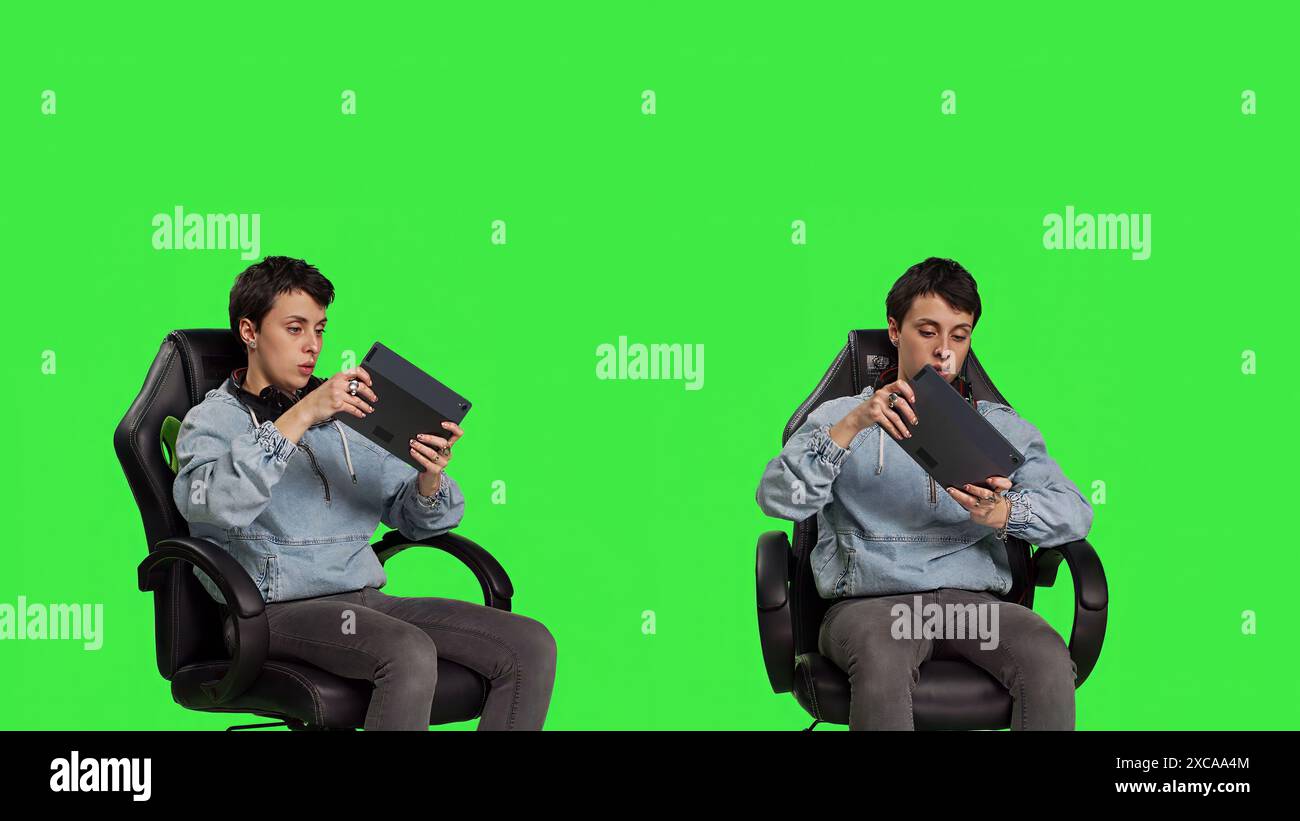 Woman focusing on online videogames tournament with tablet, sitting on ...