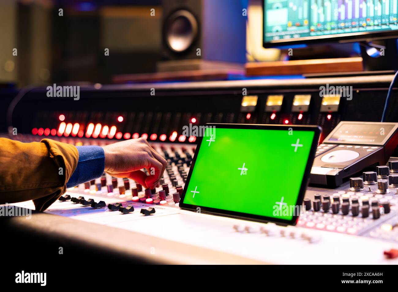 Music producer recording and processing sounds next to greenscreen ...