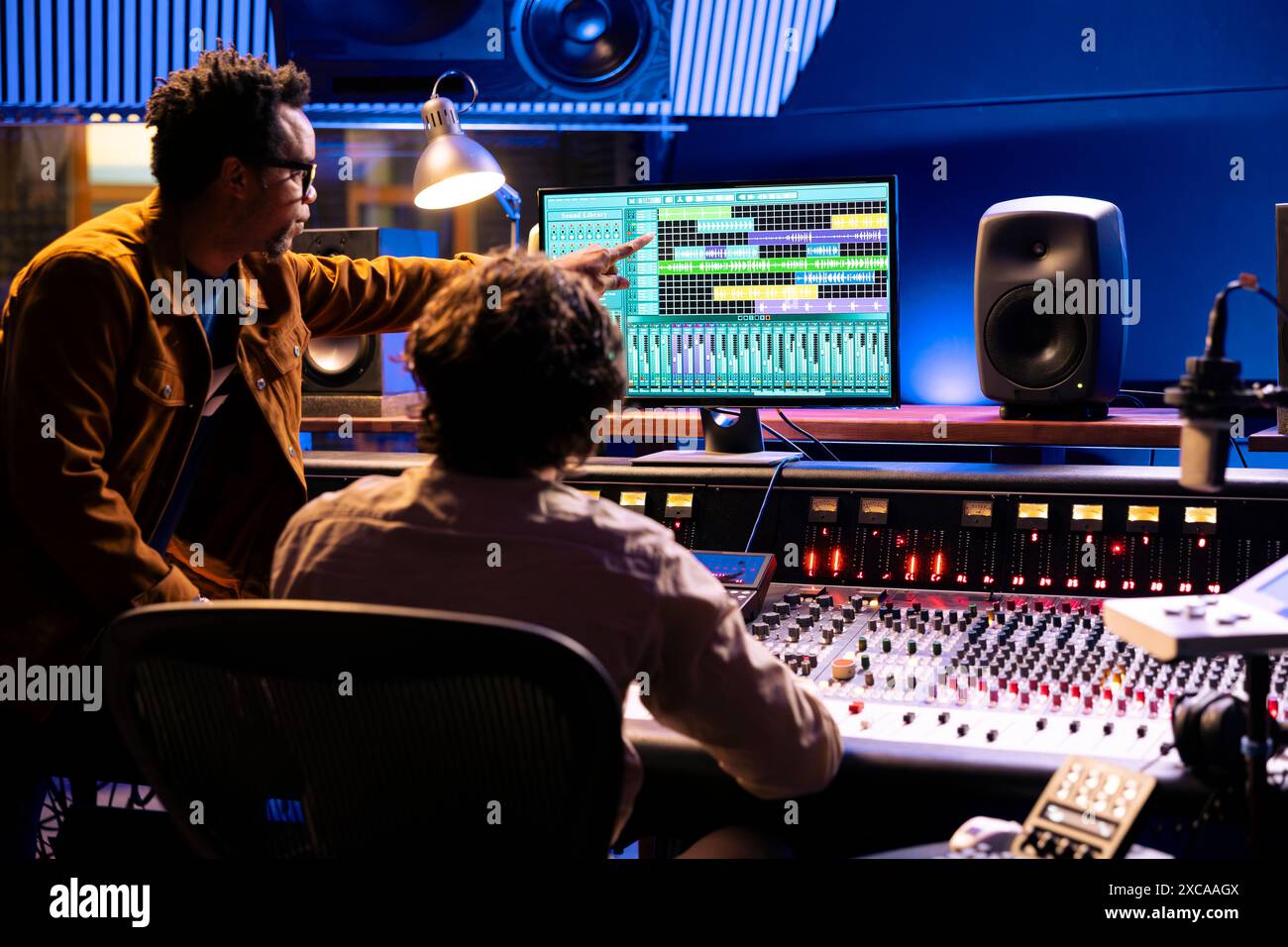 Team of artists collaborating on processing recorded files with audio ...