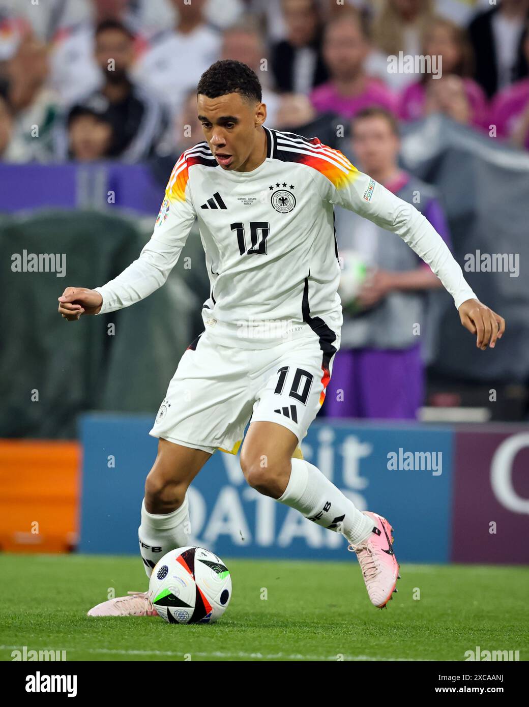 MUNICH, GERMANY - JUNE 14: Jamal Musiala of Germany runs with a ball ...