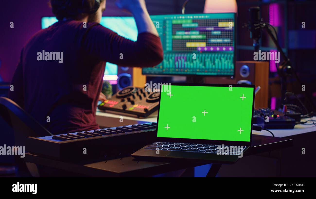 Music engineer editing audio recordings on mixing console and daw ...