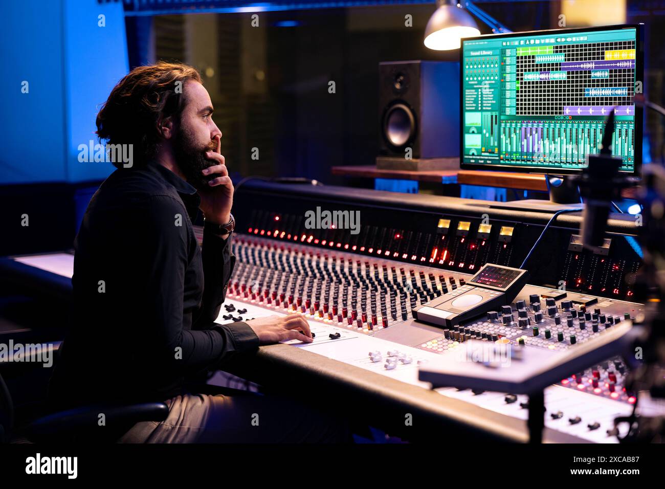 Tracking producer editing new records with digital software on pc and ...
