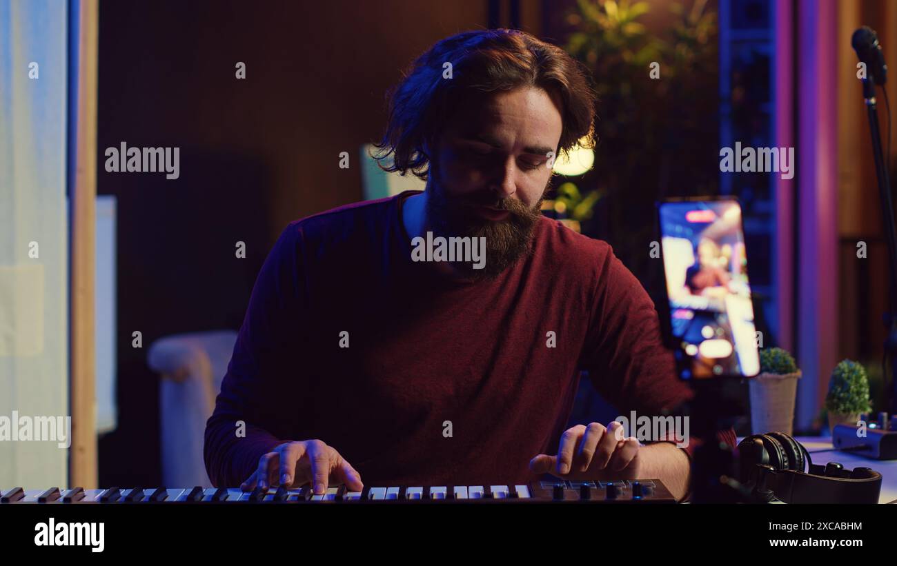 Artist teaching online piano lessons from his home studio, recording ...