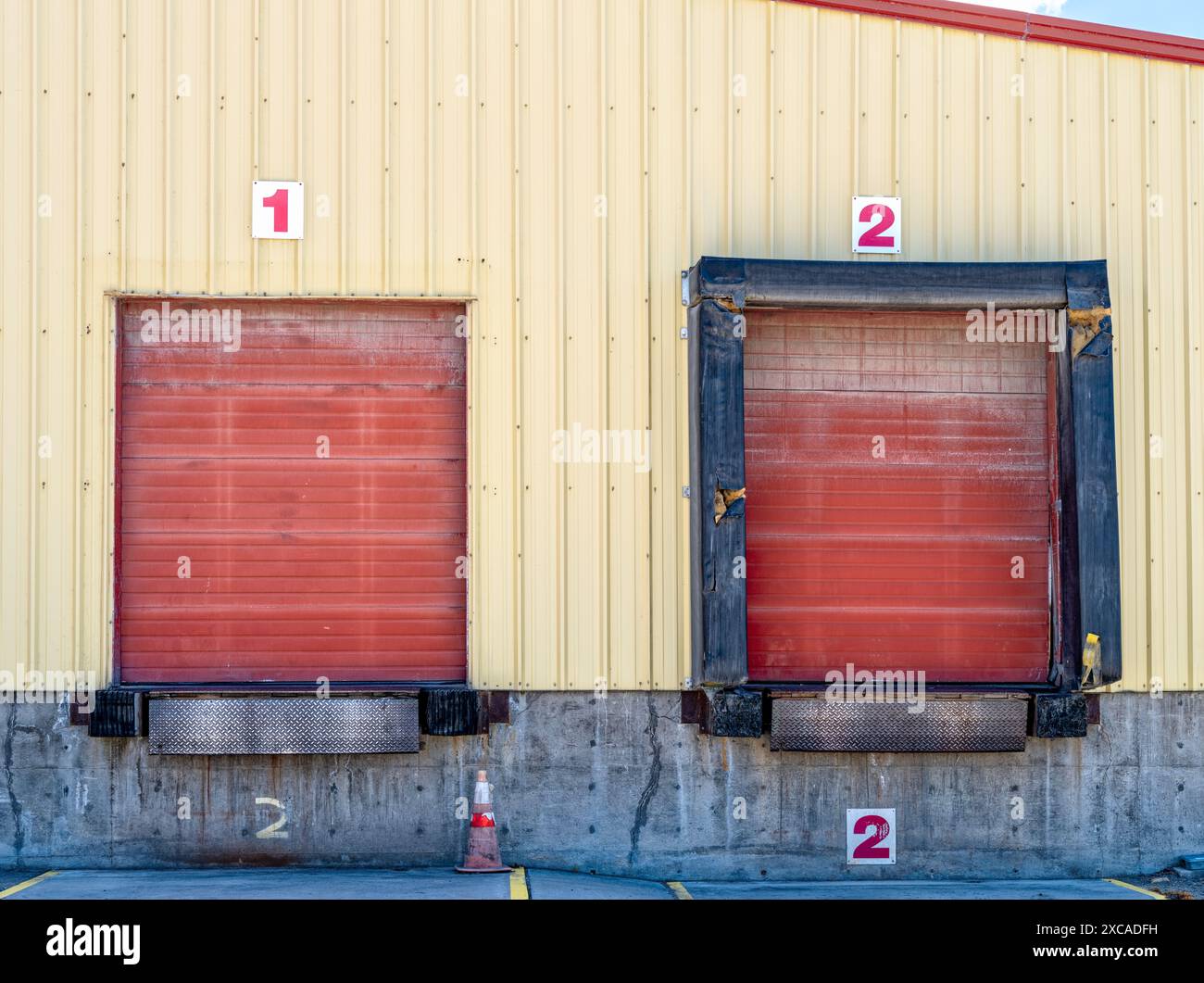 The loading dock doors numbered one and two on a metal building Stock ...