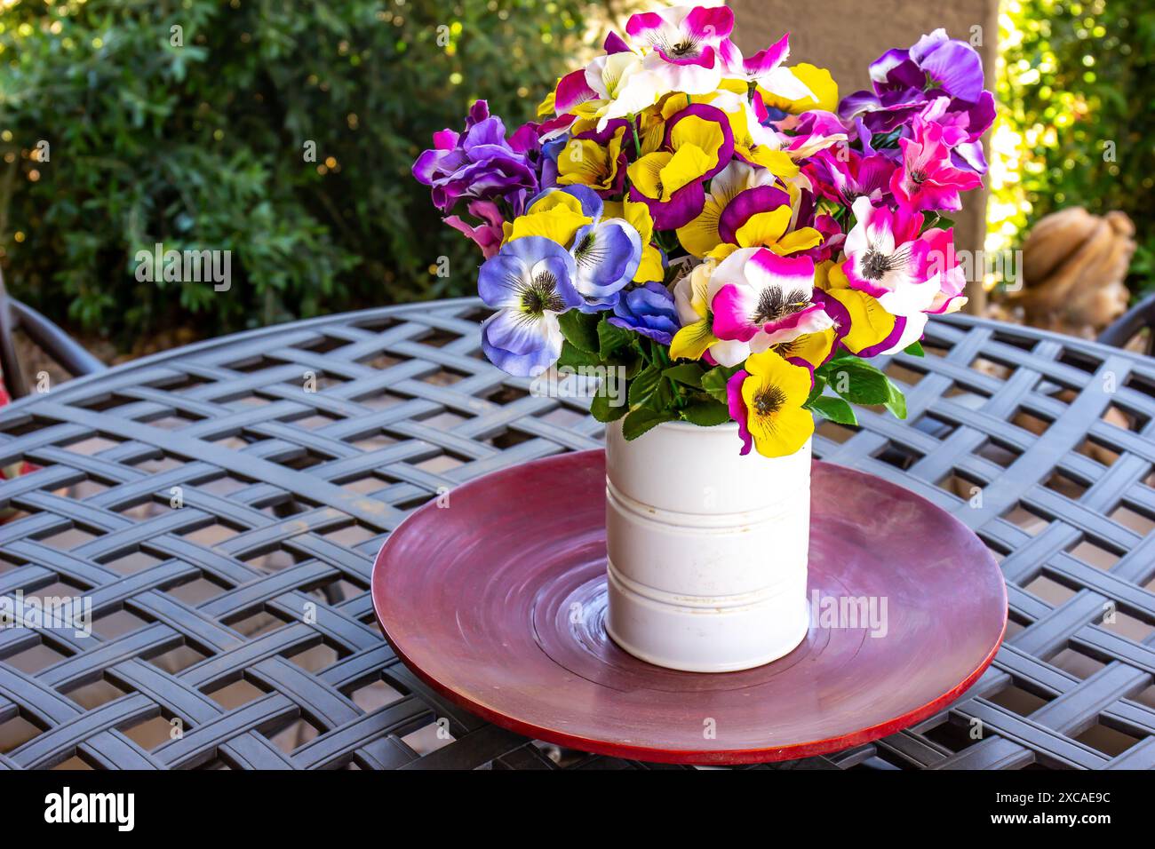 Centerpiece Of Pansies On Round Wrought Iron Table Stock Photo - Alamy