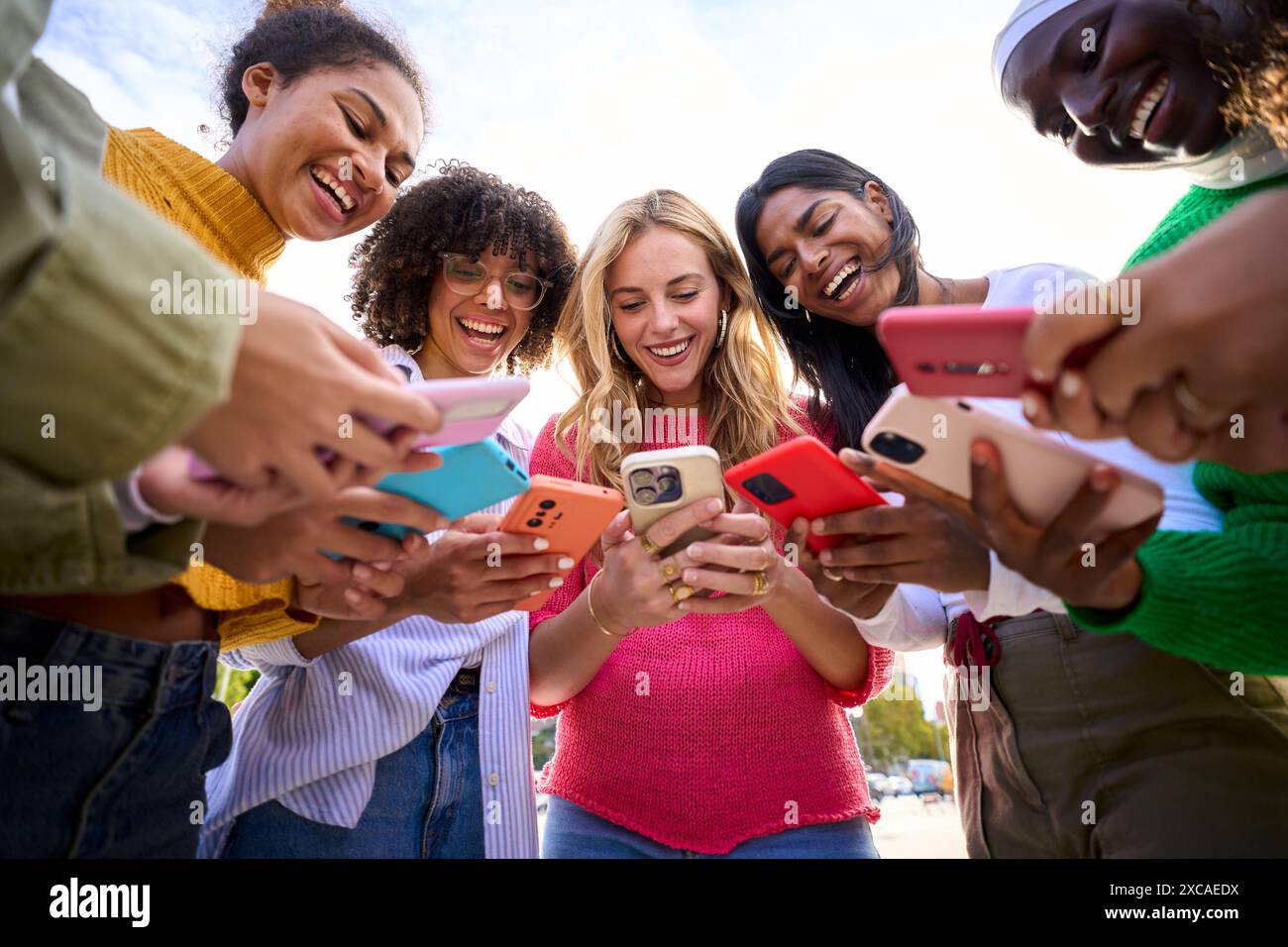 Group of international happy gen z only women laughing gathered in ...