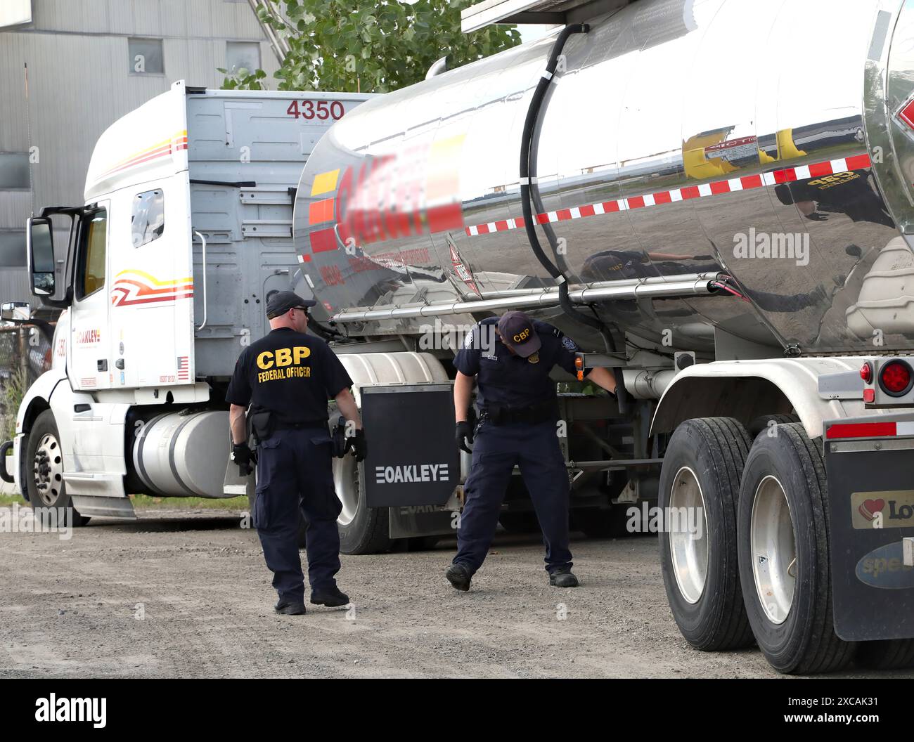 U.S. Customs and Border Protection Officers conduct inspection of ...