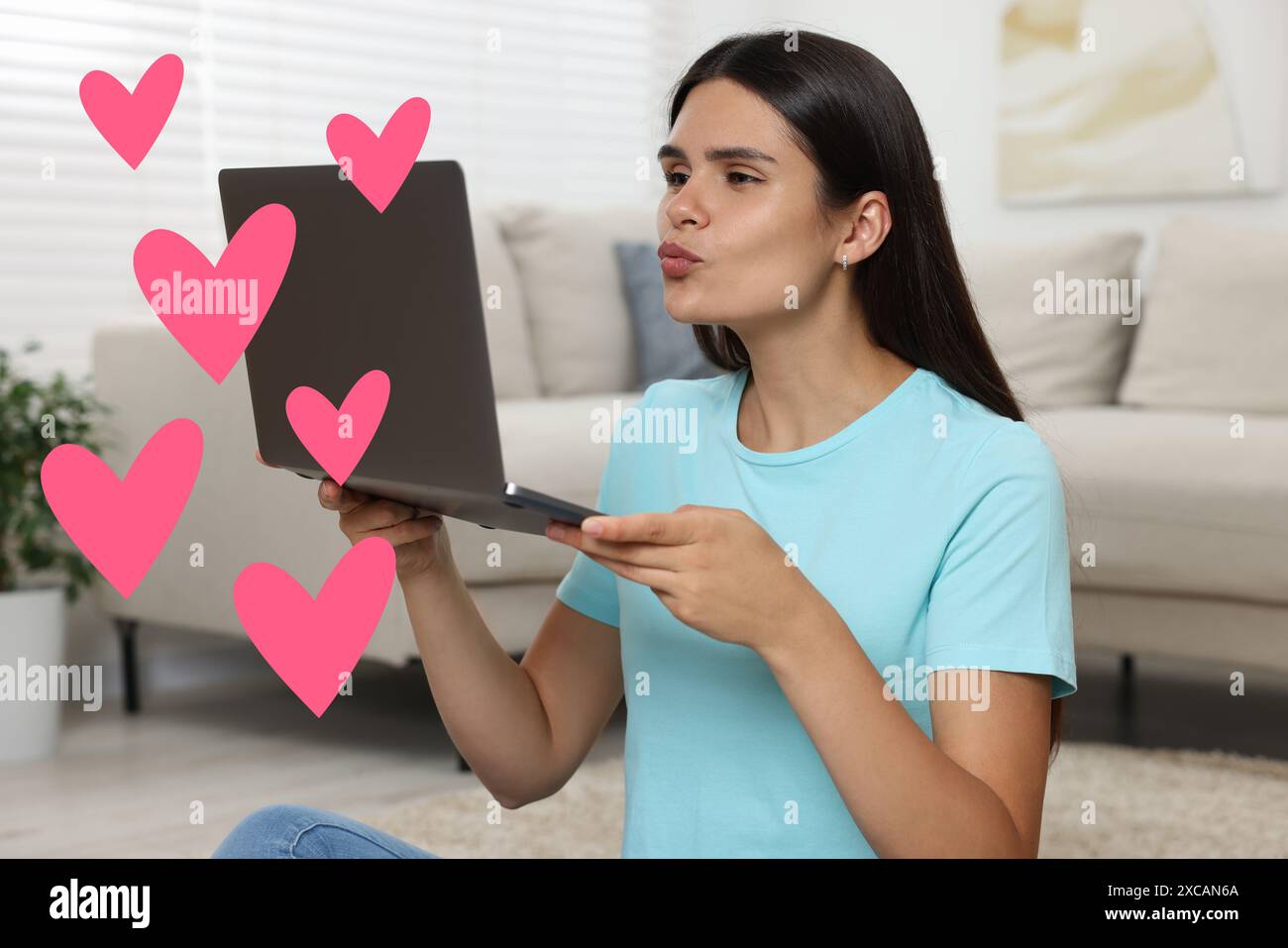 Long distance relationship. Young woman sending air kiss to her loved ...