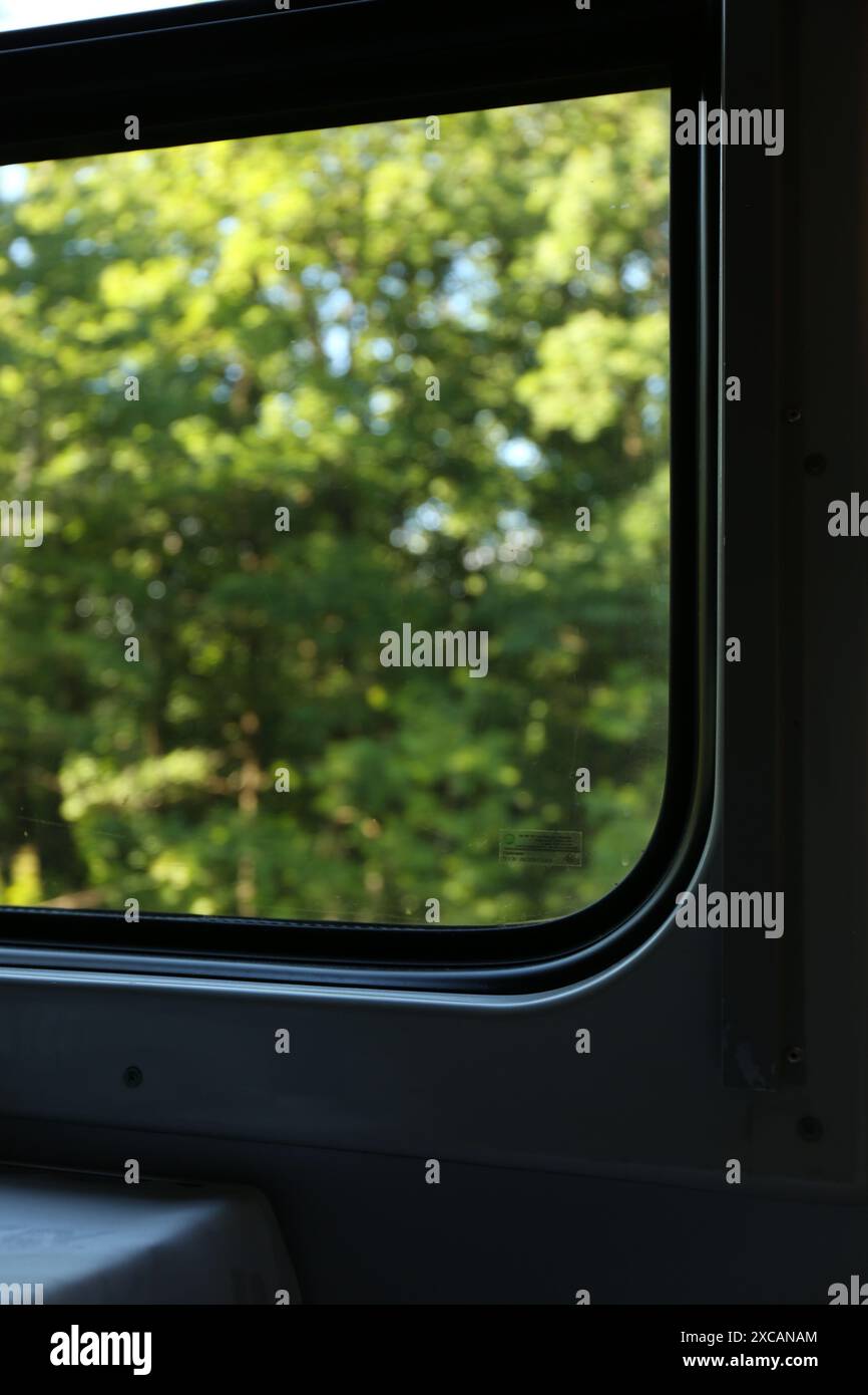 Blurred view of green trees through train window Stock Photo - Alamy