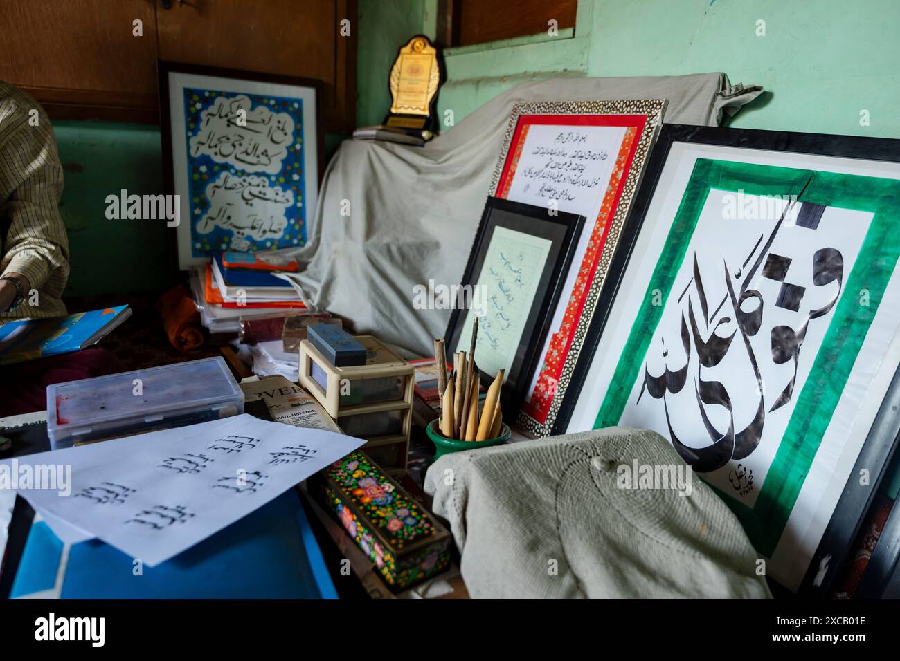 Handwritten Calligraphic work is seen at a workplace. Calligraphy is ...