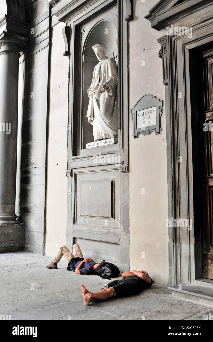 Florence, Tuscany, Italy, Europe, Two people resting under a large ...