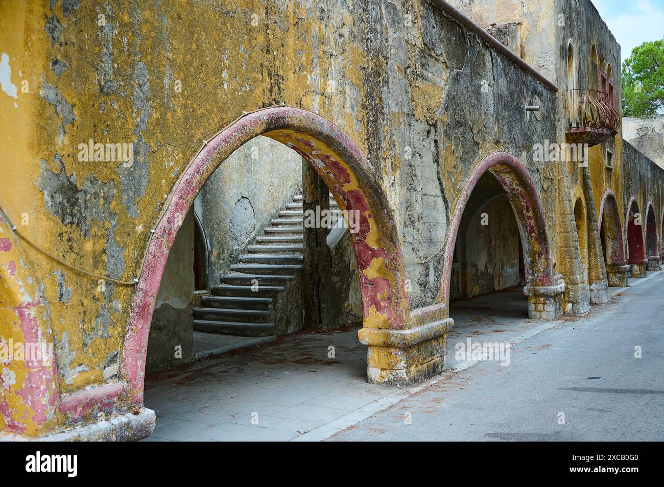 An old wall accompanied by arches showing signs of historical decay and deterioration, Italian ...