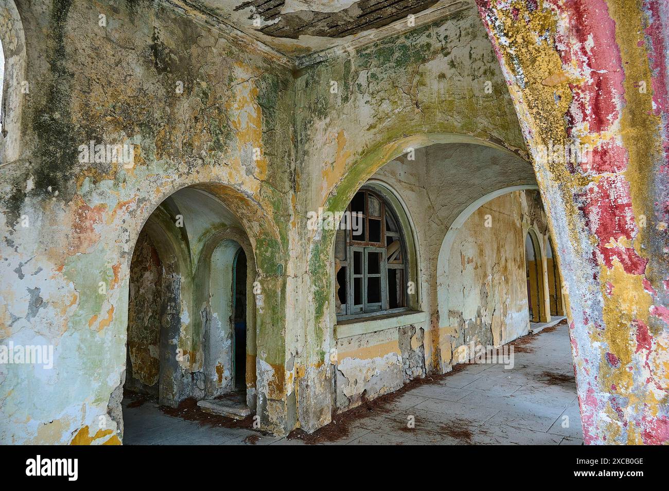 Abandoned rooms with dilapidated walls and arches, overgrown and in a ...