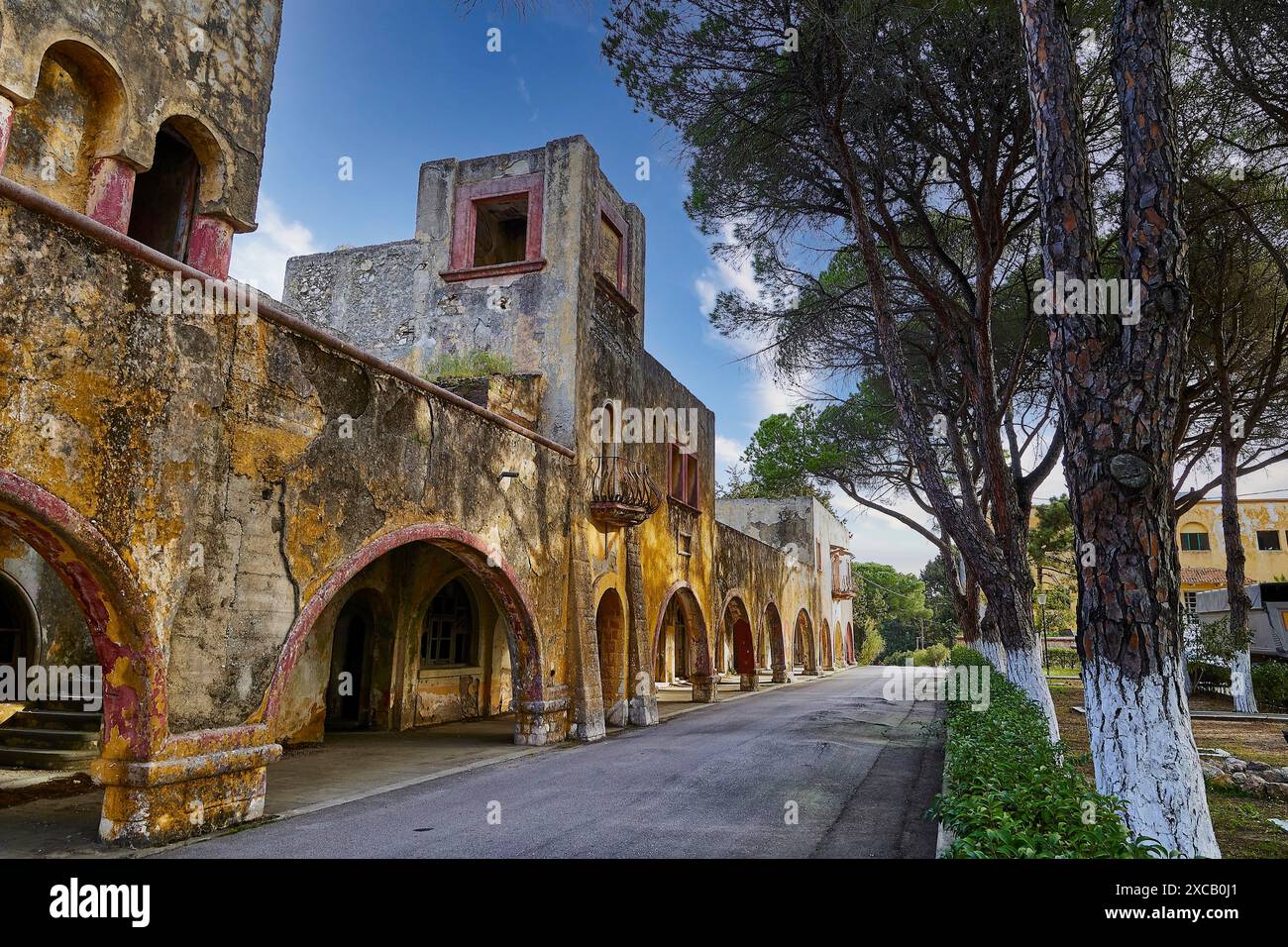 A long corridor of a historic, dilapidated building with arches and ...