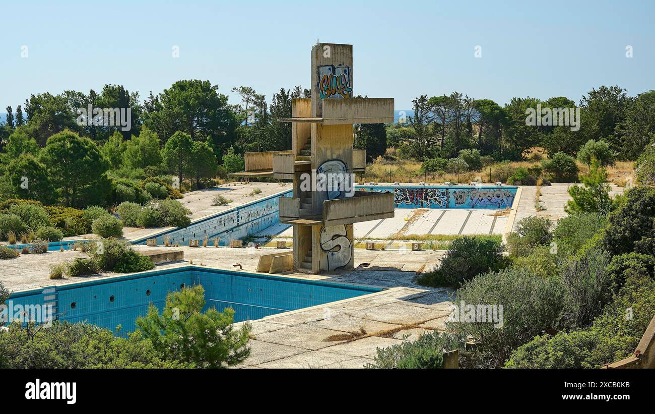 Old abandoned swimming pool with graffiti and concrete platform in ...