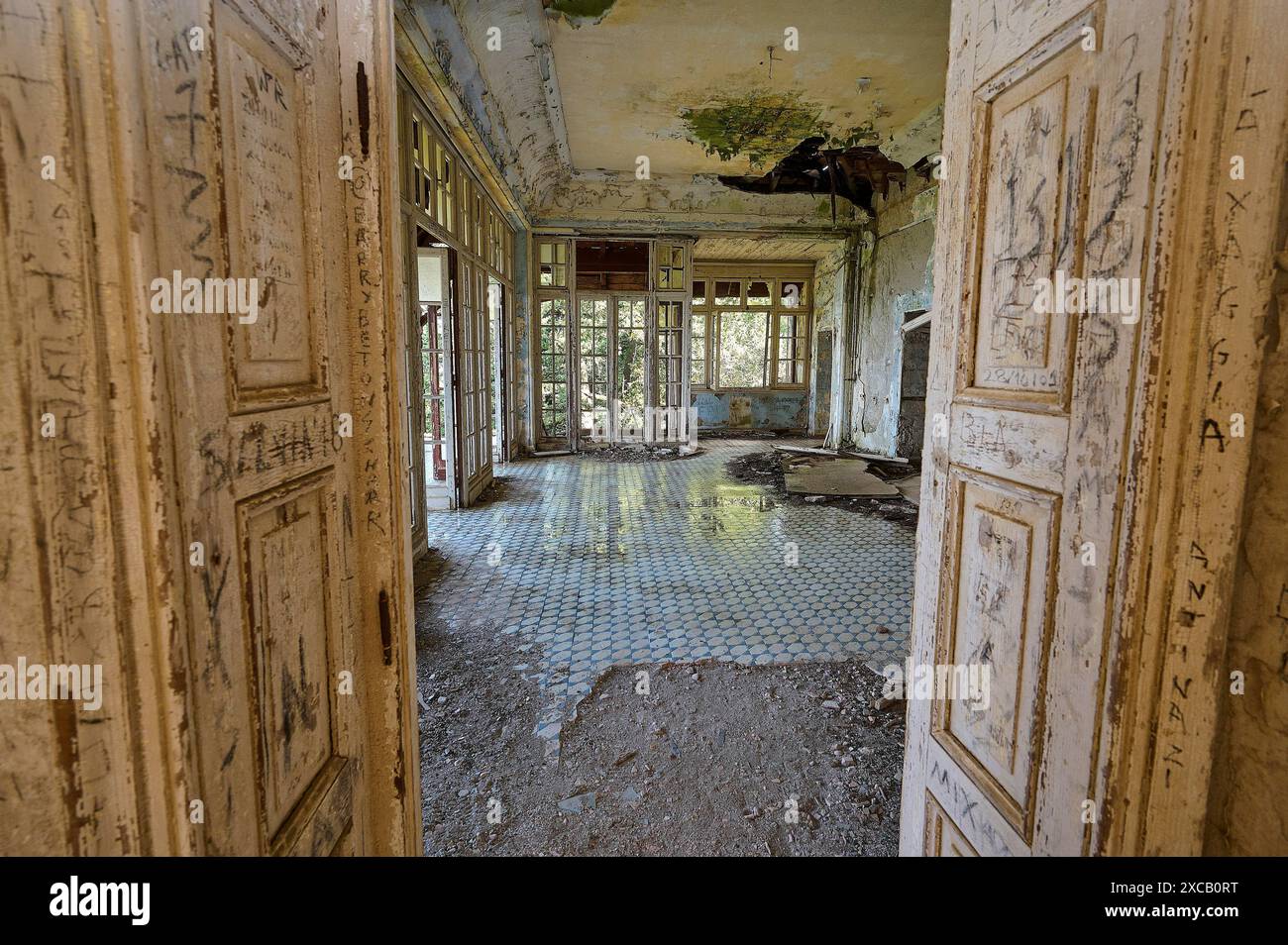 Abandoned building with large windows and dirty tiles, the dilapidated ...