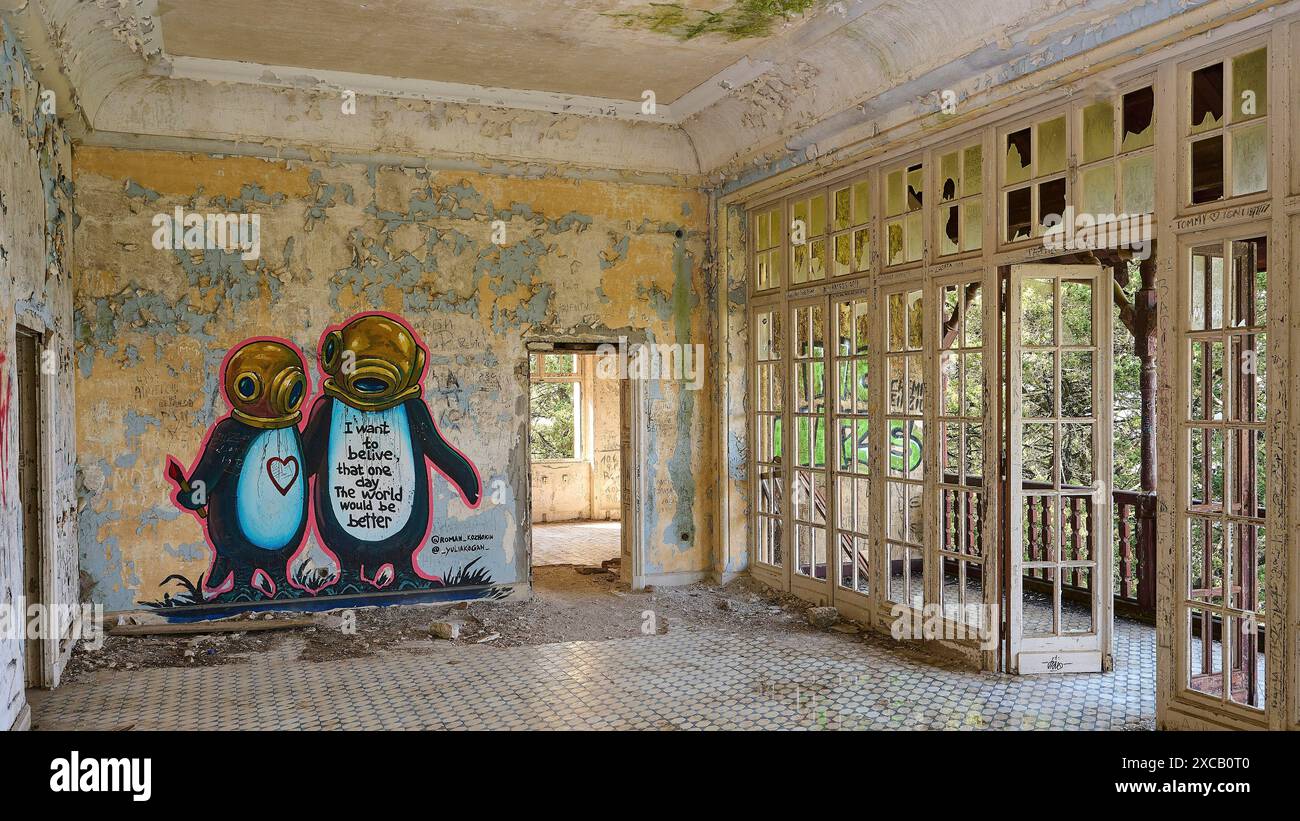 Abandoned room with graffiti on the wall, tiled floor and nature view ...