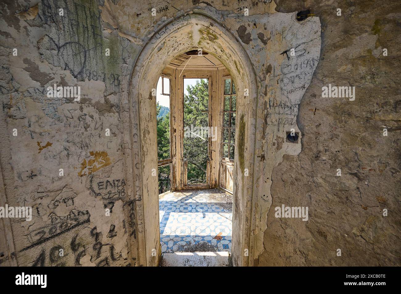 Ruin with arched windows and walls full of doodles and views of nature ...