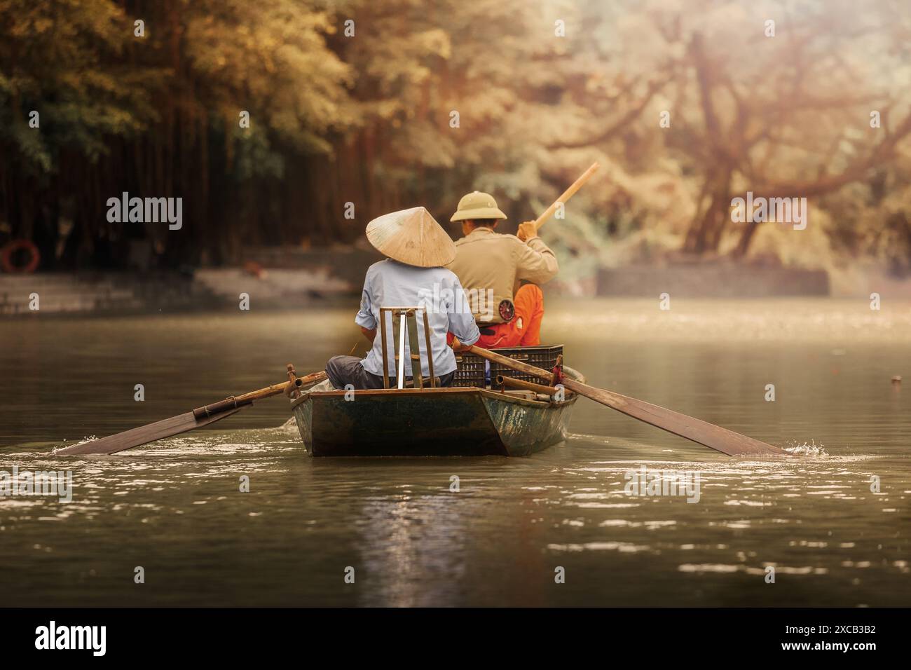Tam Coc village boat tour in Vietnam. Man and a women rowing the Tam ...