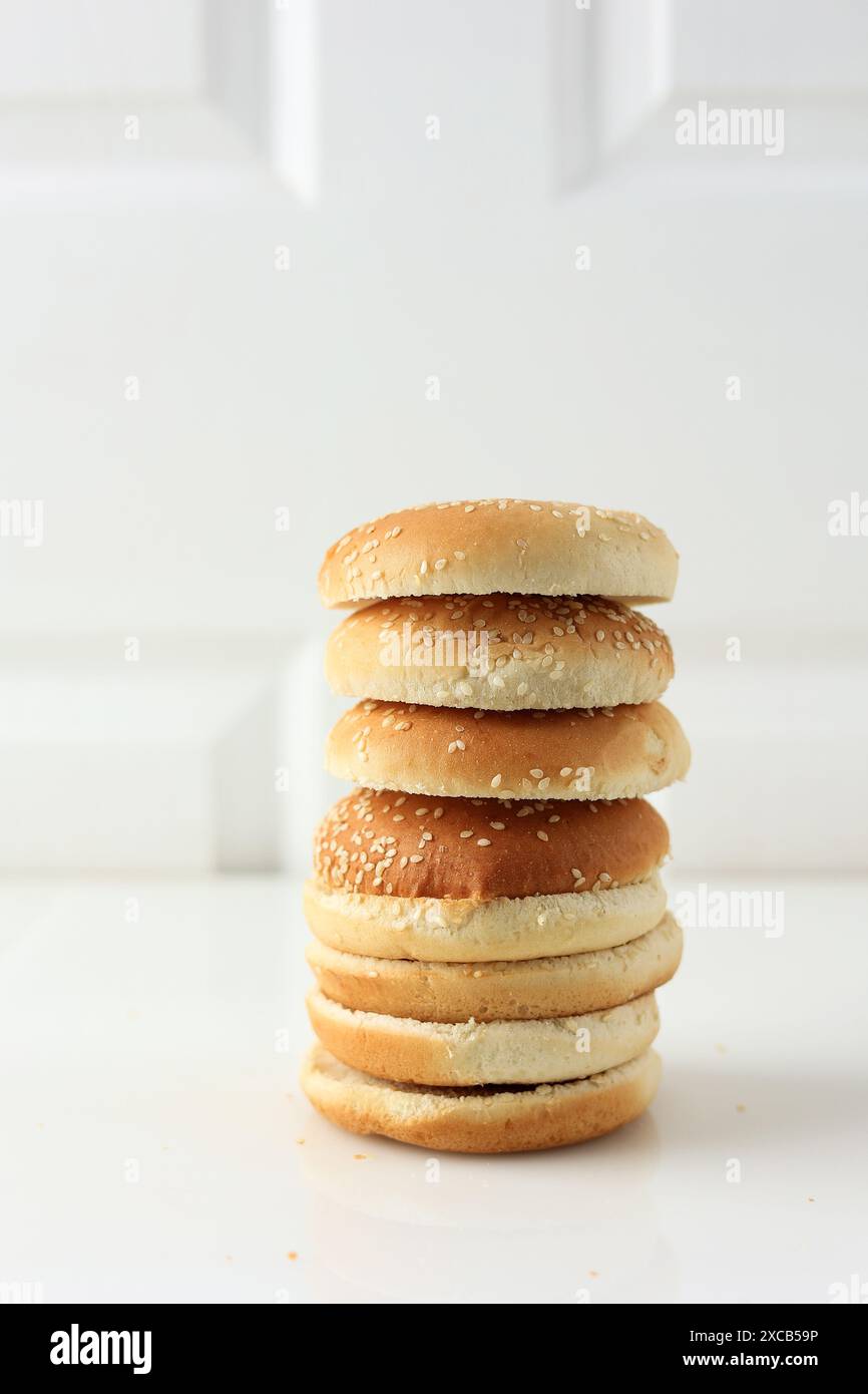 Stacked Burger Bun with Sesame Seed, on White Table Stock Photo - Alamy