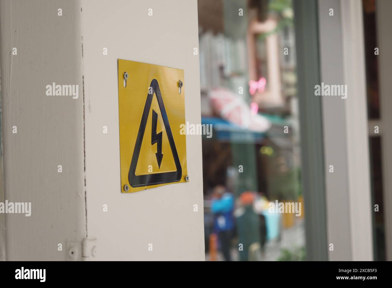 Two electrical boxes with lightning bolt on brick wall Stock Photo - Alamy