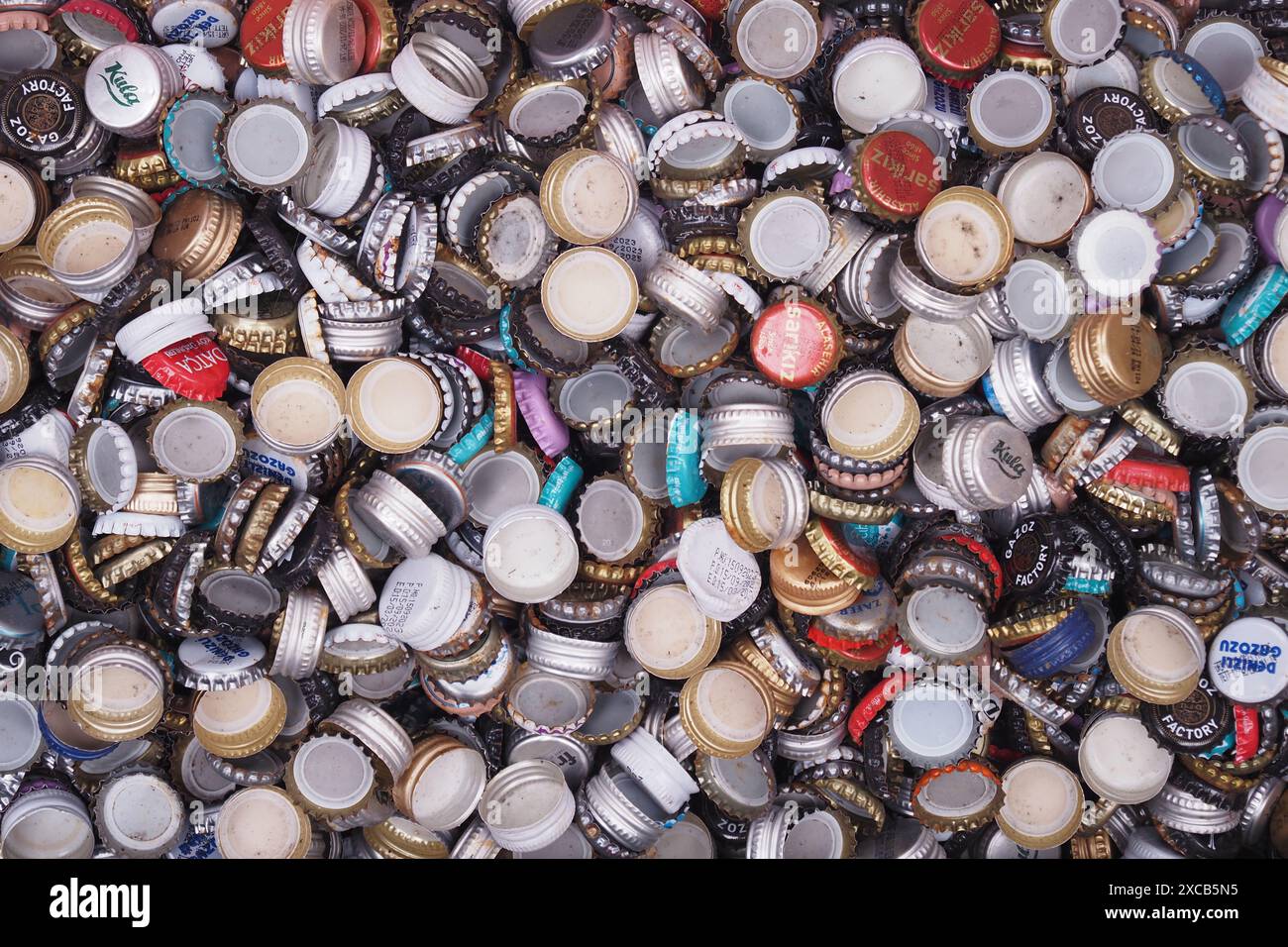 Assorted bottle caps create a colorful background, ideal for beverage ...