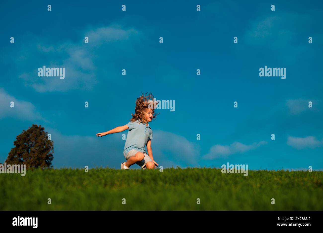 Kid running on grass field. Cute boy run in summer park. Child running ...