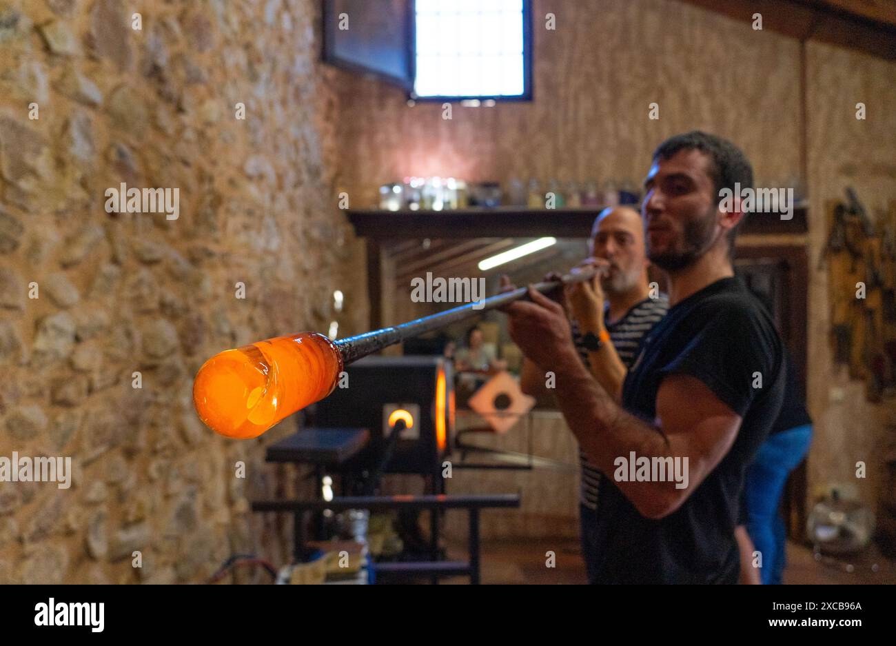 Artisans creating a piece of blown glass in an artisanal glass blowing workshop Stock Photo - Alamy