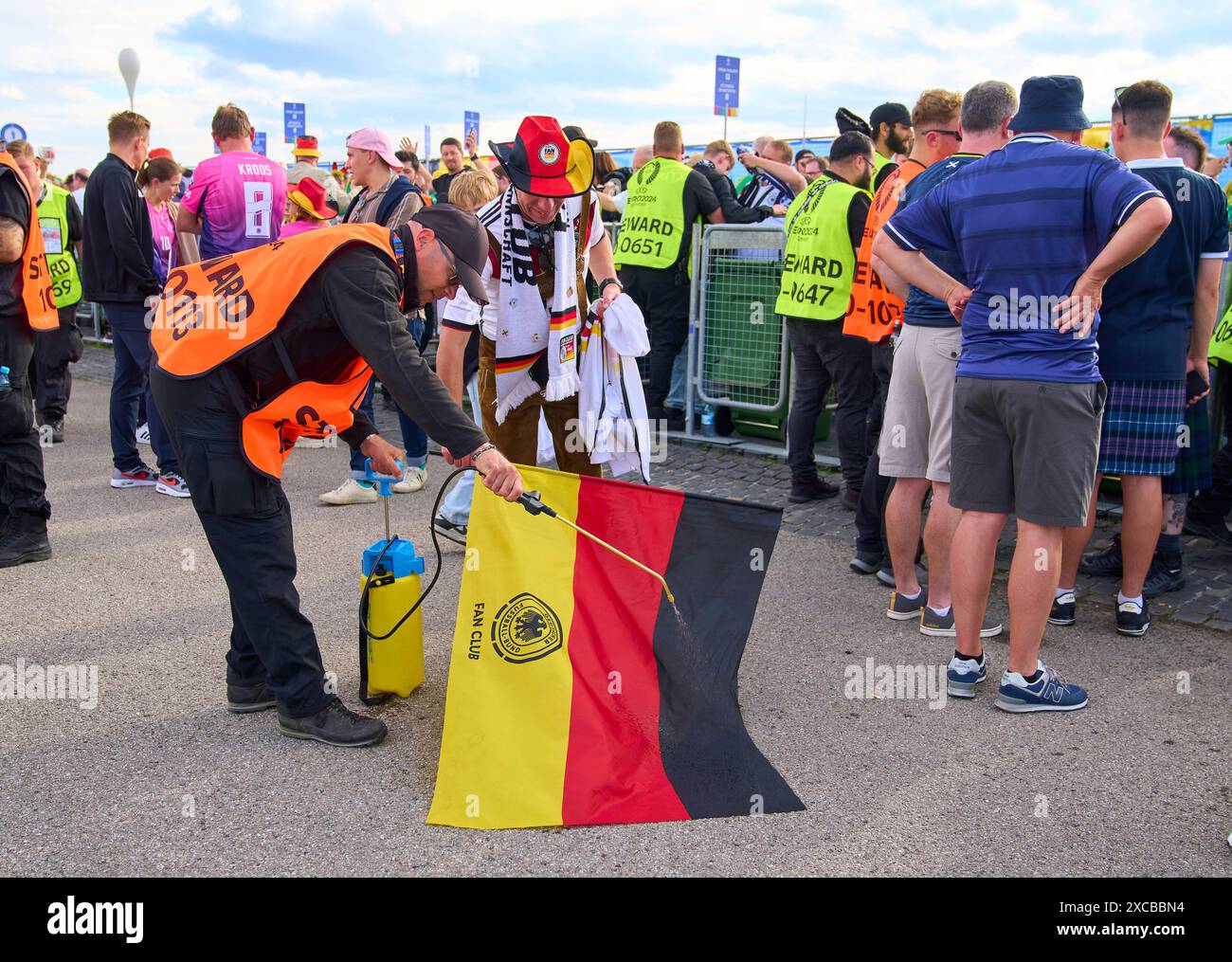 Security worker sprays anti flammable fluid on flags in the group stage ...