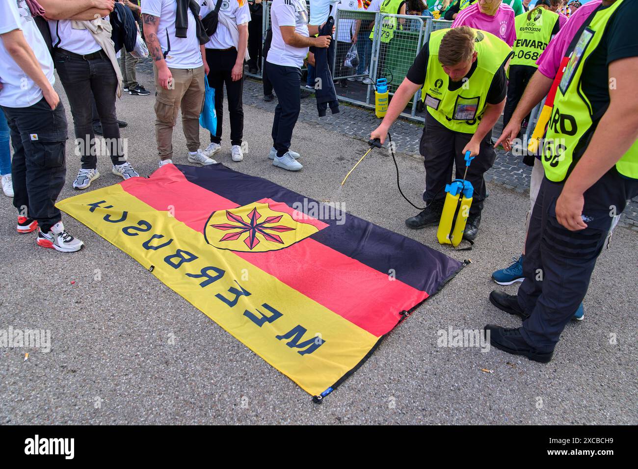 Security sprays anti flammable fluid on fan flags in the group stage ...