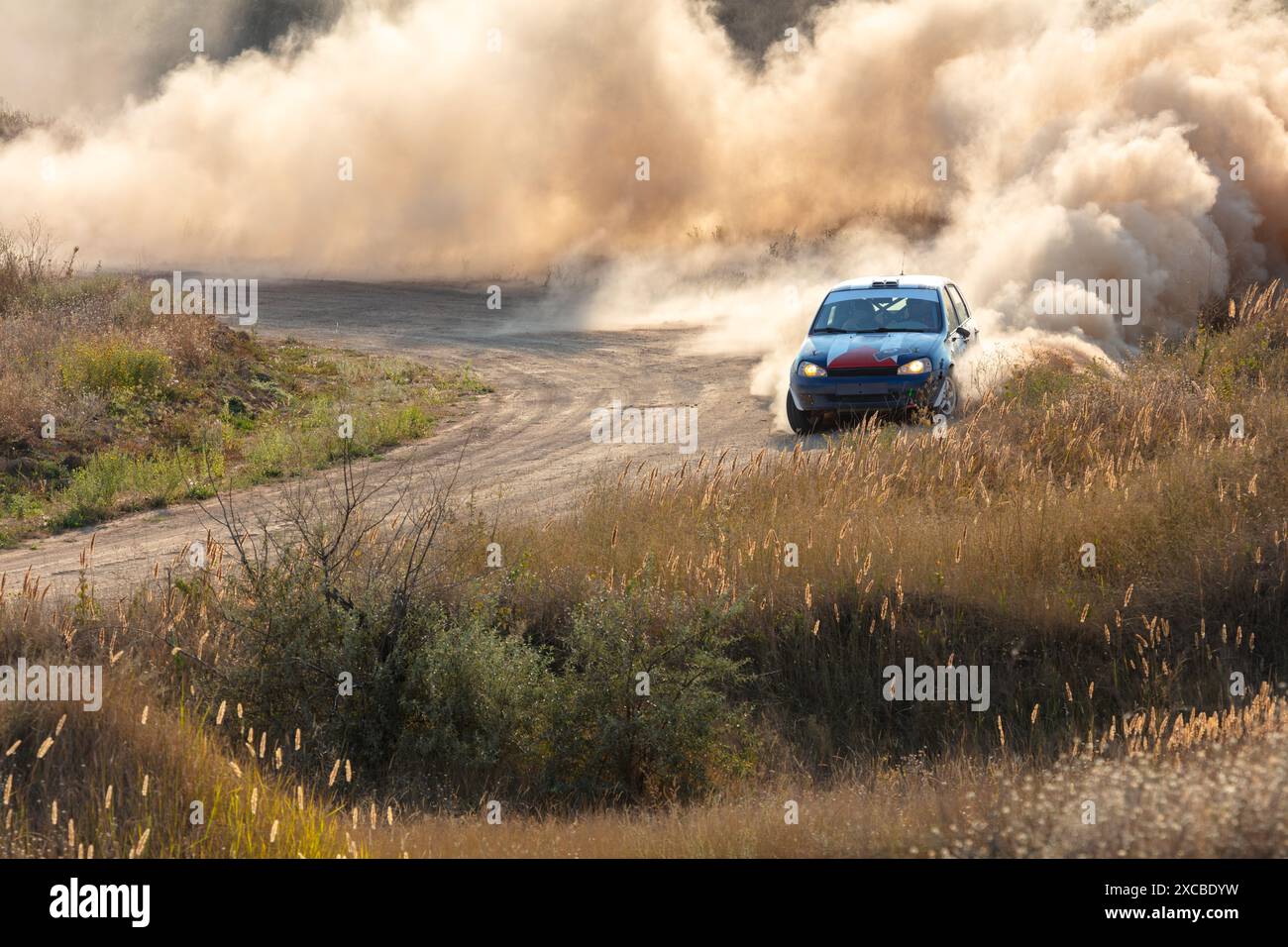 Sunny summer day. A sharp turn on a dirt rally track. A rally car ...