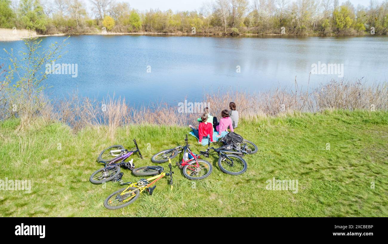 Family on bikes cycling outdoors, active parents and kids on bicycles ...