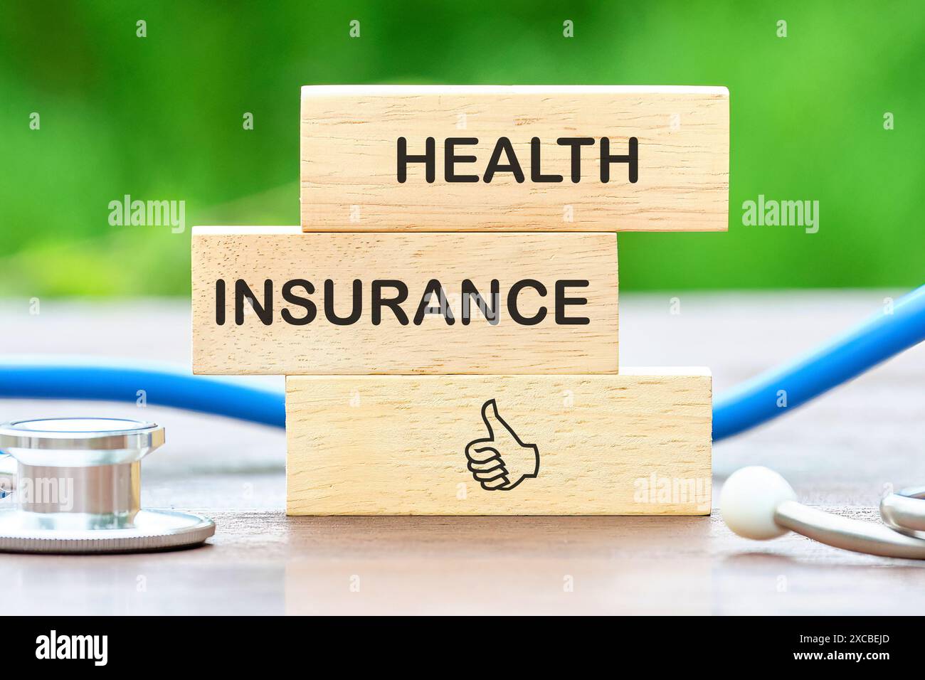 Health insurance text written on wooden bars next to the stethoscope ...
