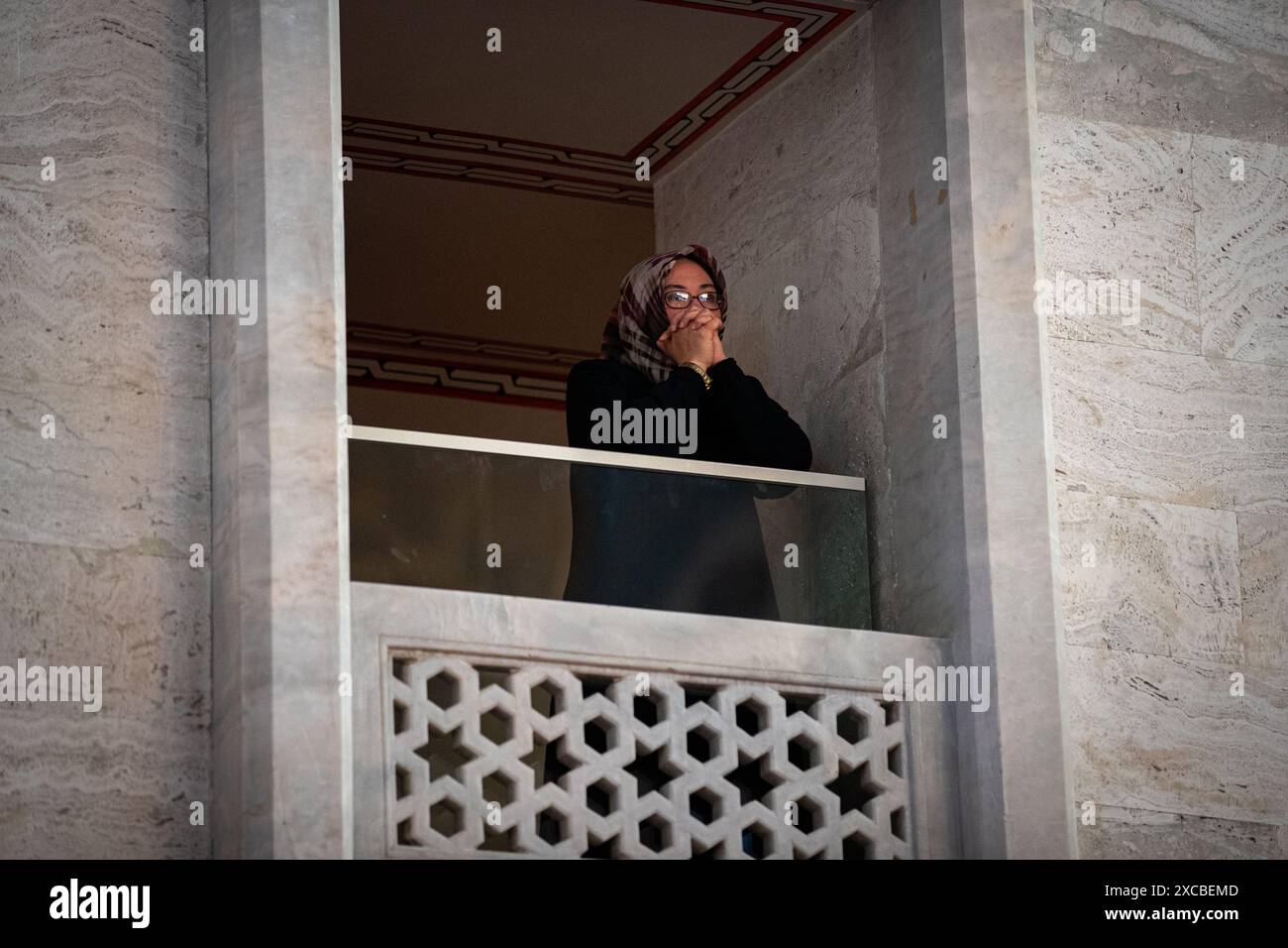 A woman prays during the Eid sermon. Eid al-Adha is a religious holiday ...