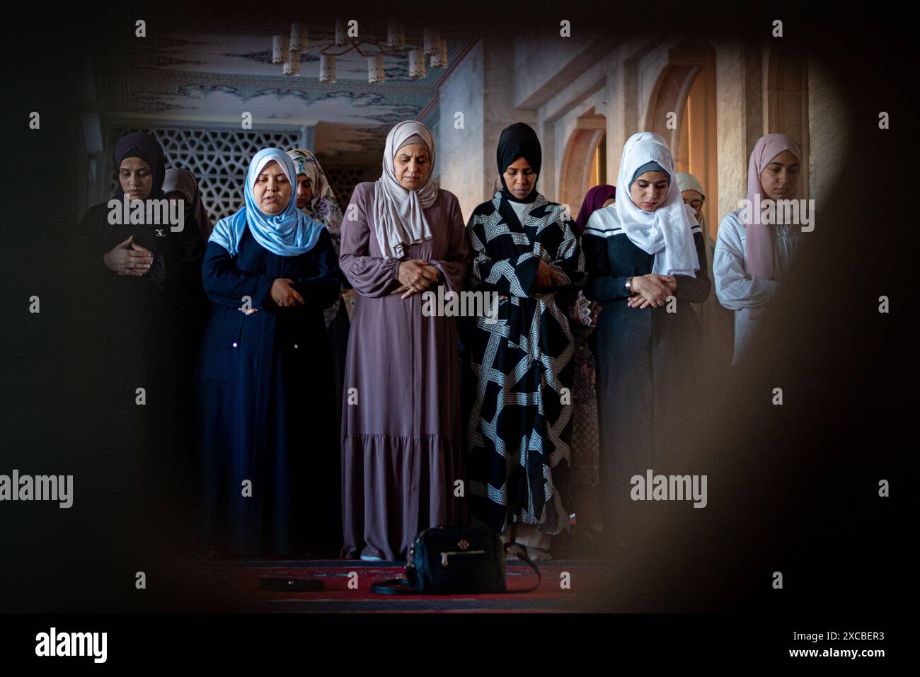 Muslim women perform Eid prayers. Eid al-Adha is a religious holiday ...