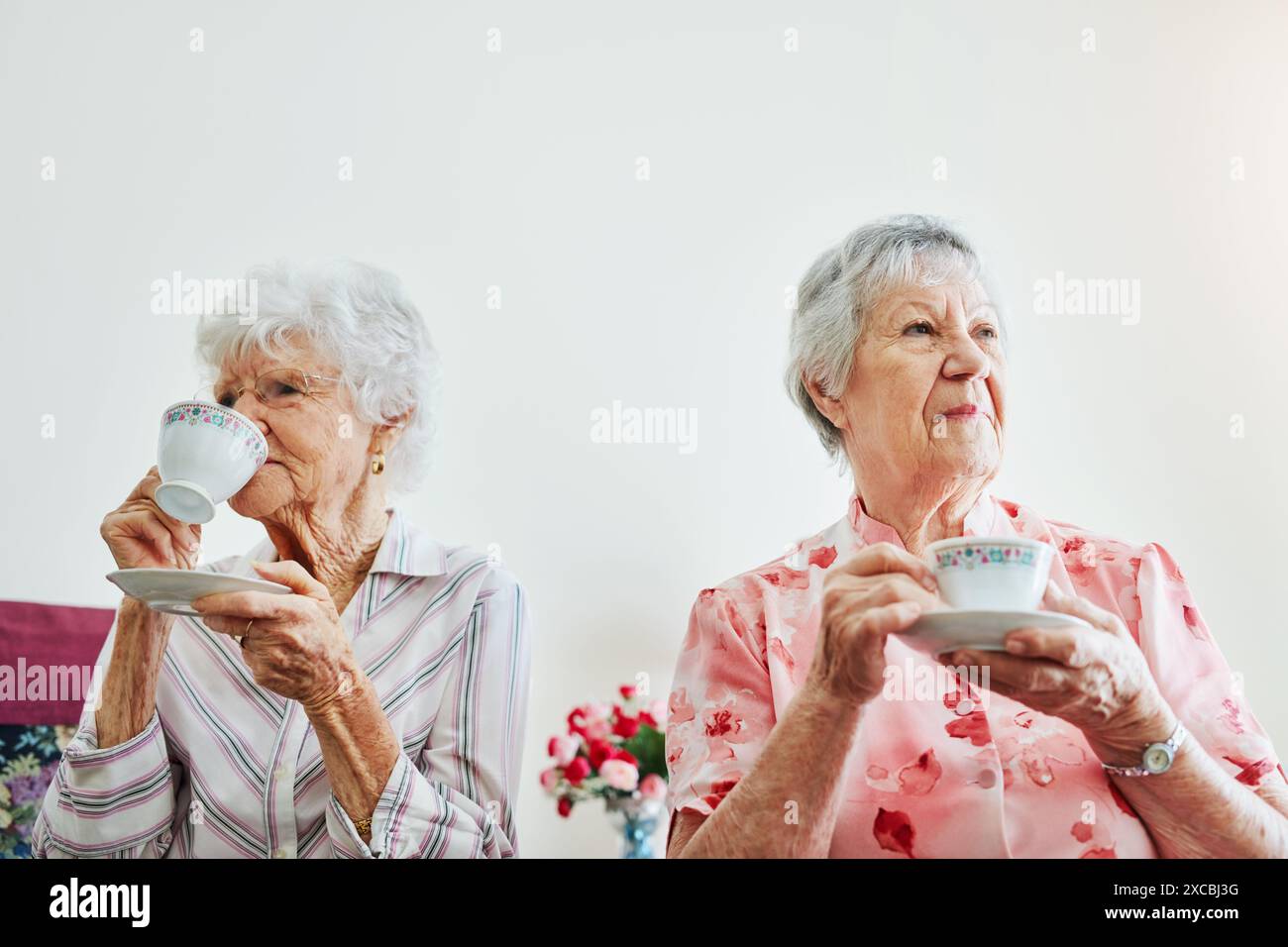 Elderly women, friends and tea cup in living room with for thinking ...