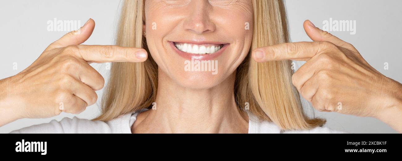 Mature woman pointing teeth hi-res stock photography and images - Alamy