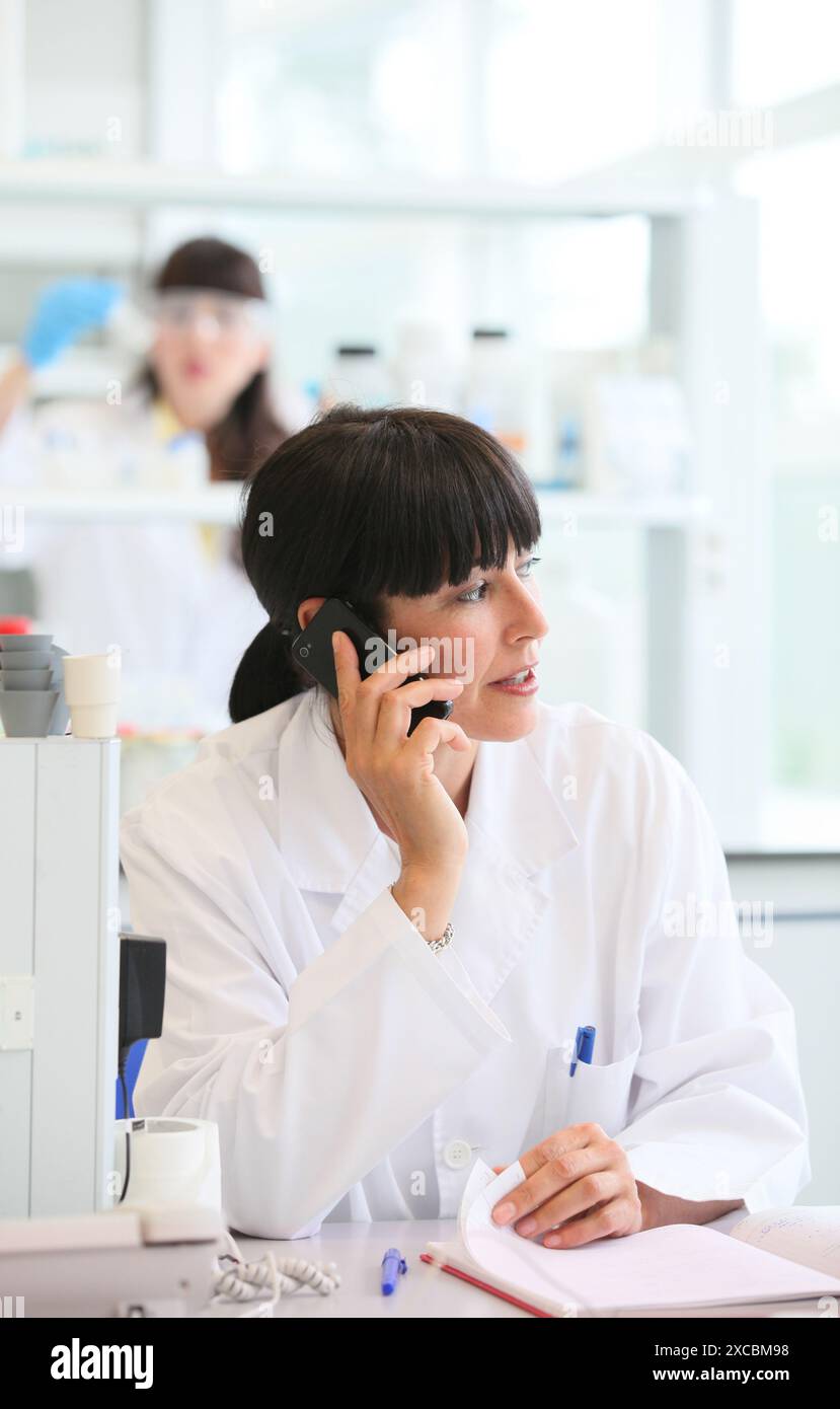 Researchers working on chemical synthesis hi-res stock photography and ...