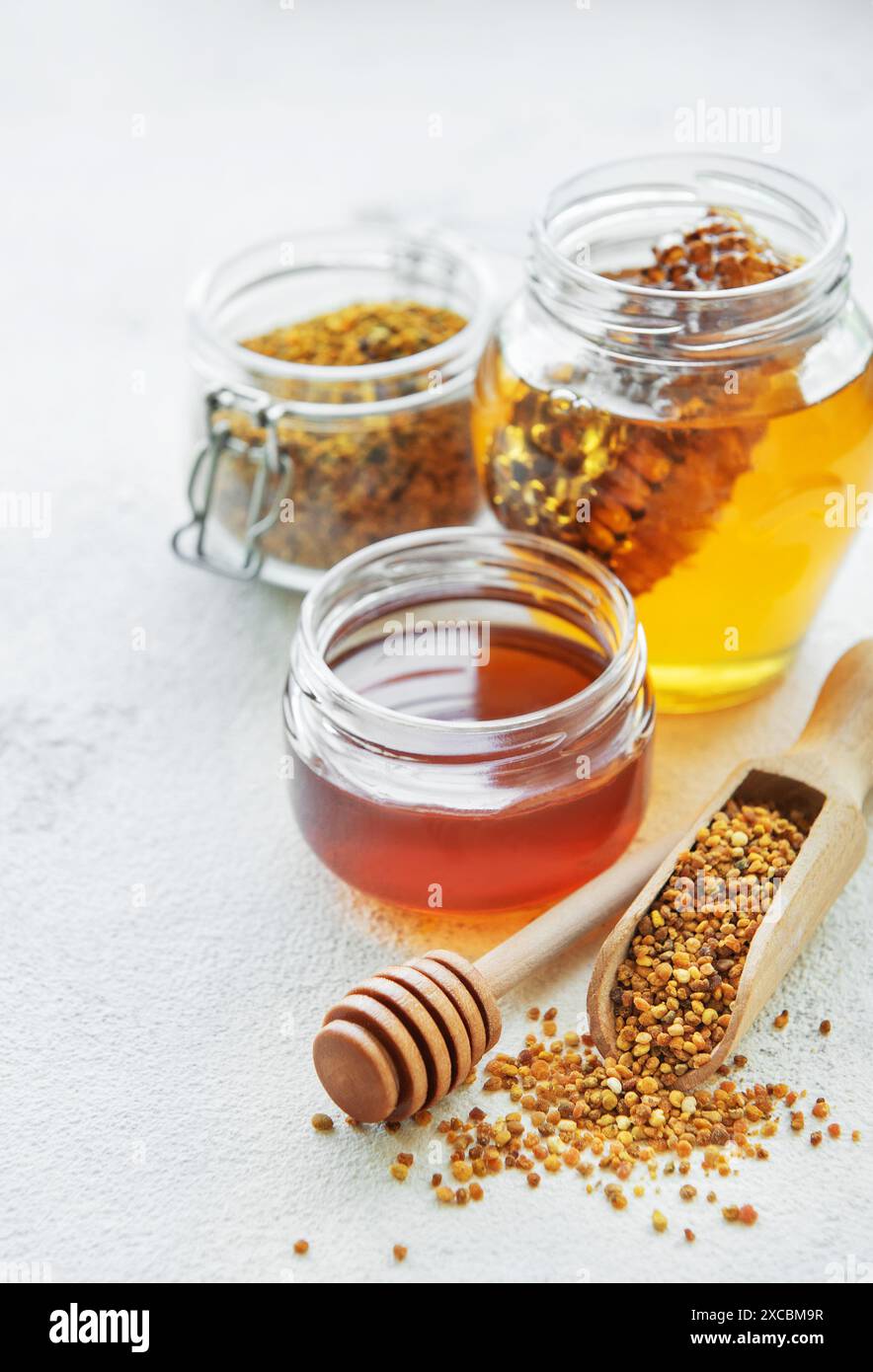 Raw organic bee pollen and honey in jars Stock Photo - Alamy