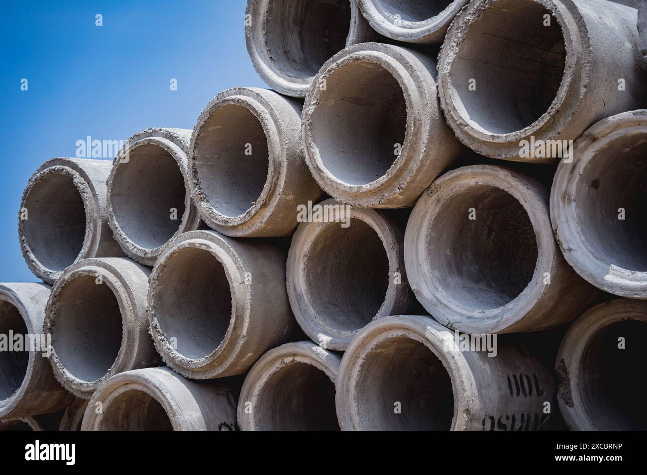 A stack of concrete ring pipes piled and creating a symmetrical ...