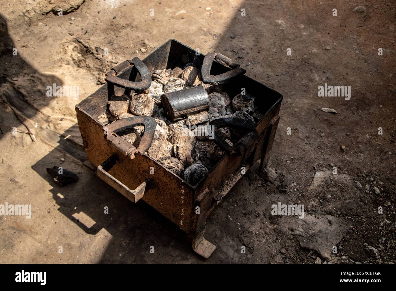 General view of a stove commonly known as a jiko with burning briquette ...