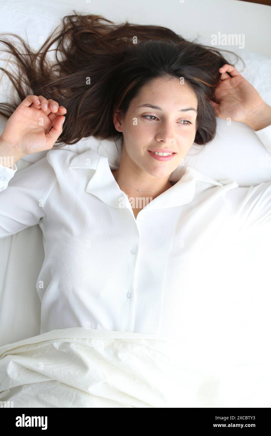 Young woman in bed Stock Photo - Alamy