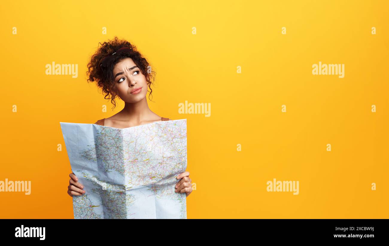 Young Woman Looking Puzzled While Holding a Map Stock Photo - Alamy